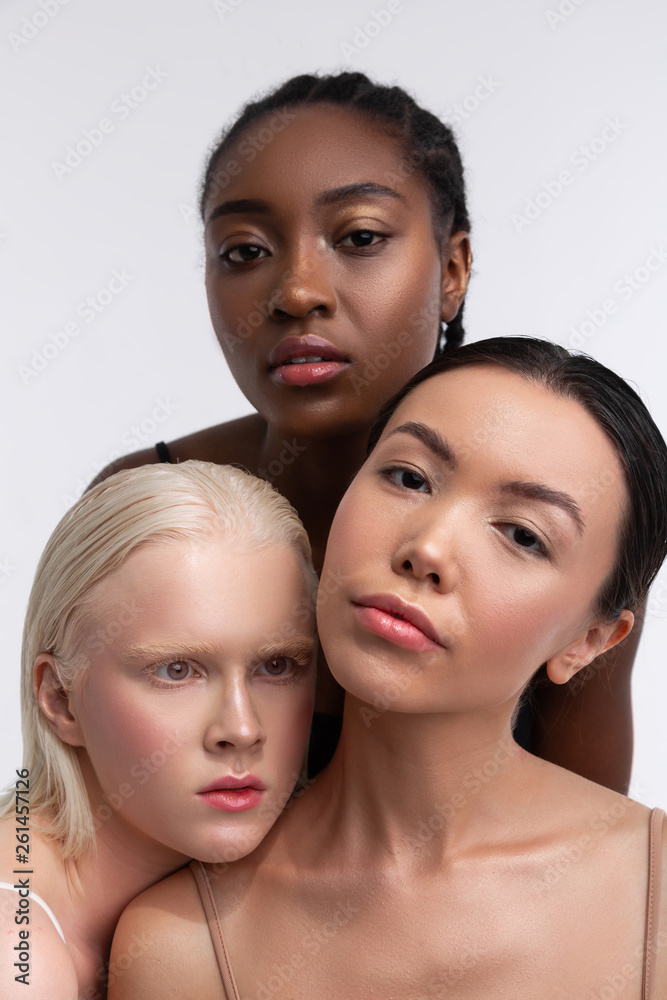 Three models working for international magazine posing together Stock ...