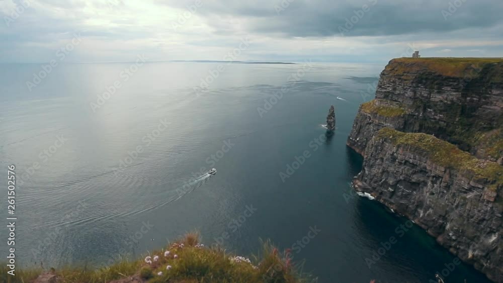 CLIFFS OF MOHER, IRELAND. A lonely ship moving along the rocky ...
