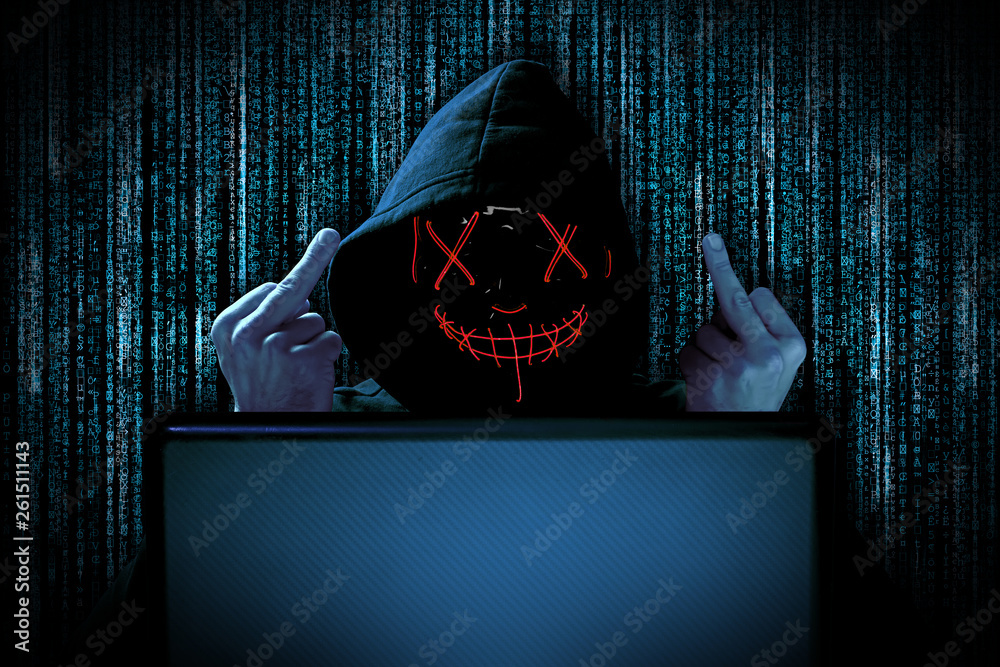 hacker with middle fingers gesture provocation red glowing mask behind ...