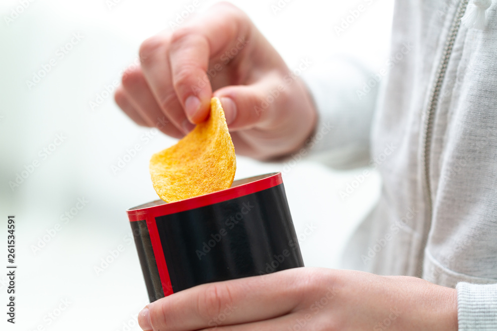 Person holding chips box with potato crunchy salted spicy chips in ...