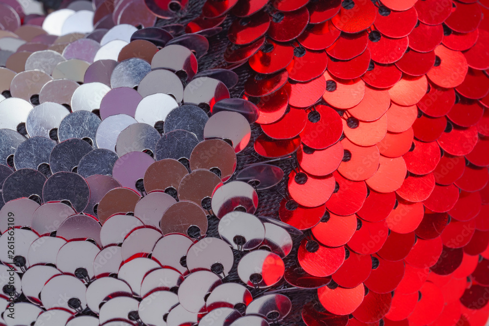 Texture of bilateral sequins. Red and silver double-sided sequins ...