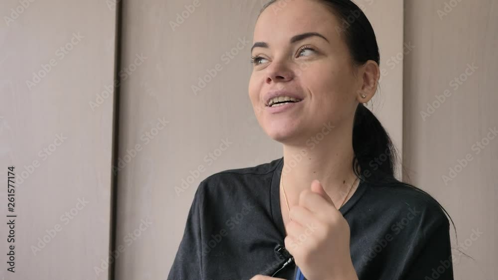 A beautiful young white girl cheerfully tells an interesting story ...
