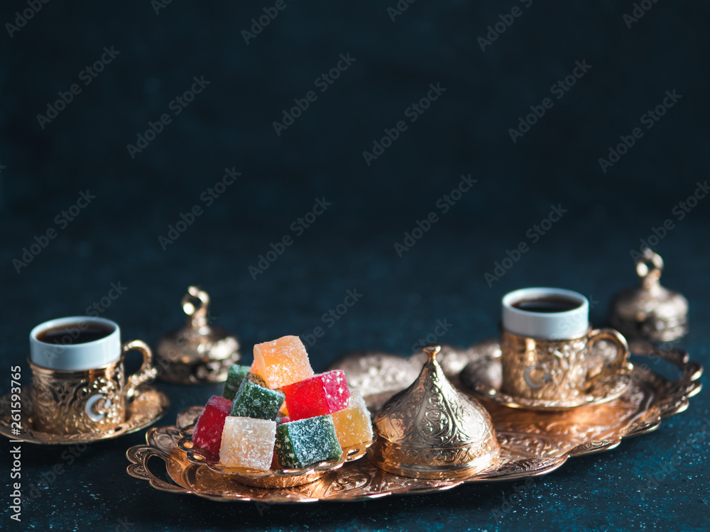 Turkish coffee with delight and traditional copper serving set on dark ...