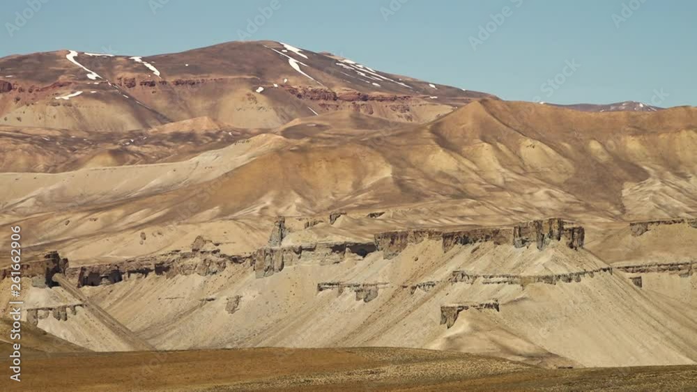 Sand dunes, mounds with snowy mountains. Band-e Amir Lakes. Band-e Amir ...