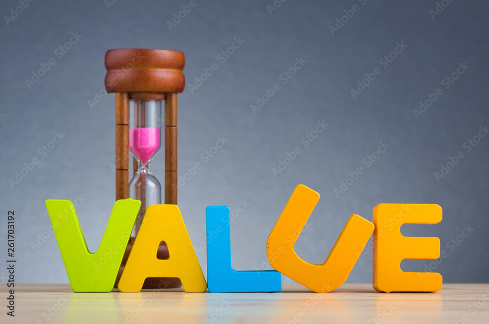 VALUE word made with wooden letter on desk over gently lit dark ...