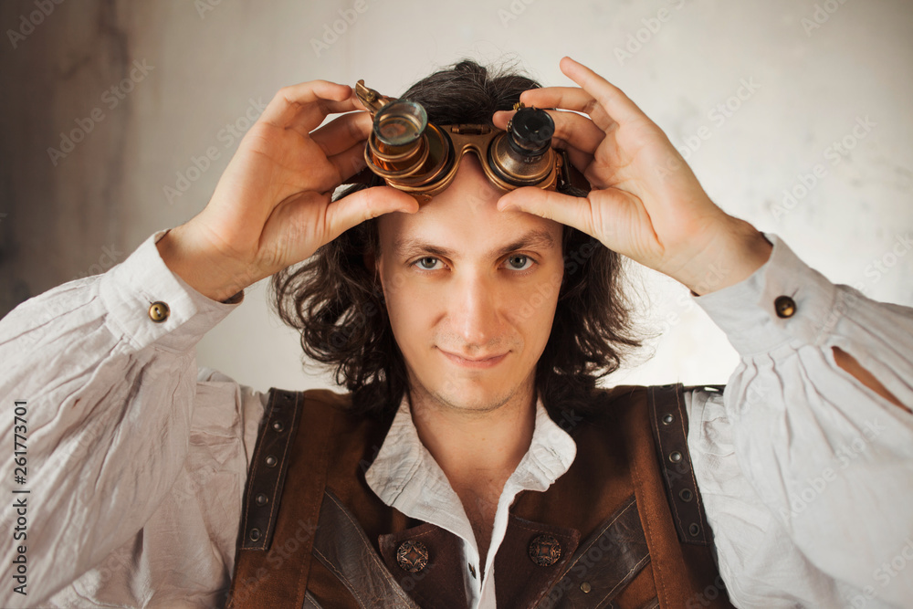 Steampunk pilot in a leather vest and flight glasses on his forehead ...