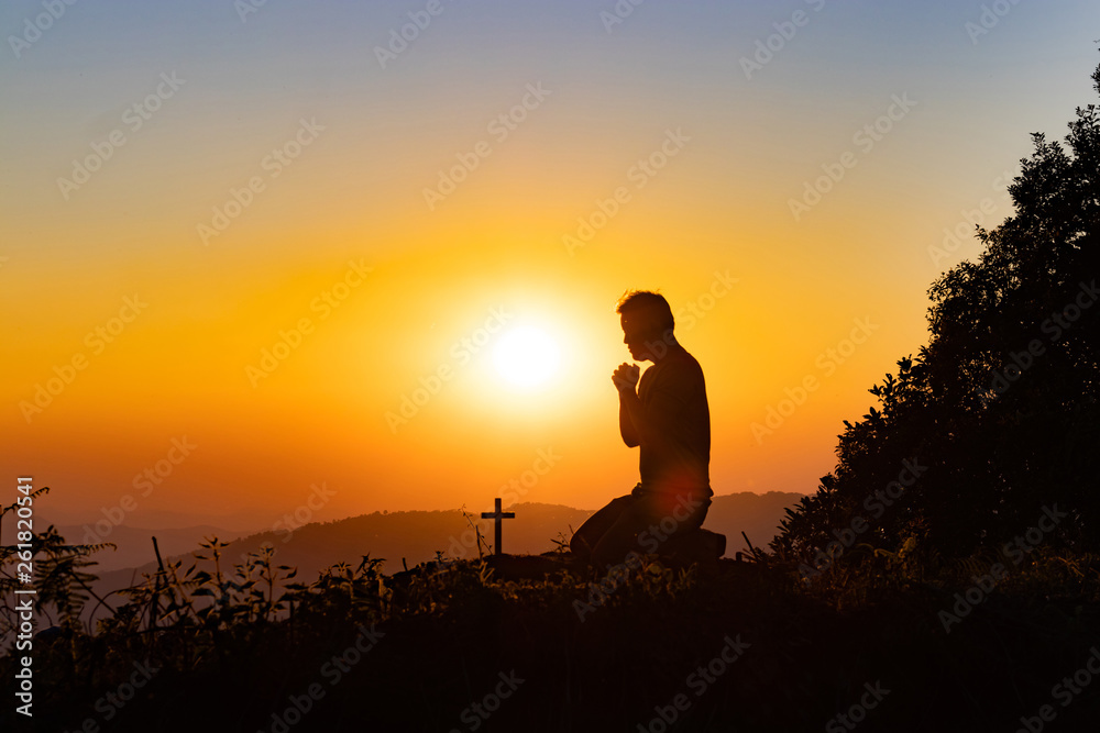 Fotka „Silhouette of woman praying with cross in nature sunrise ...