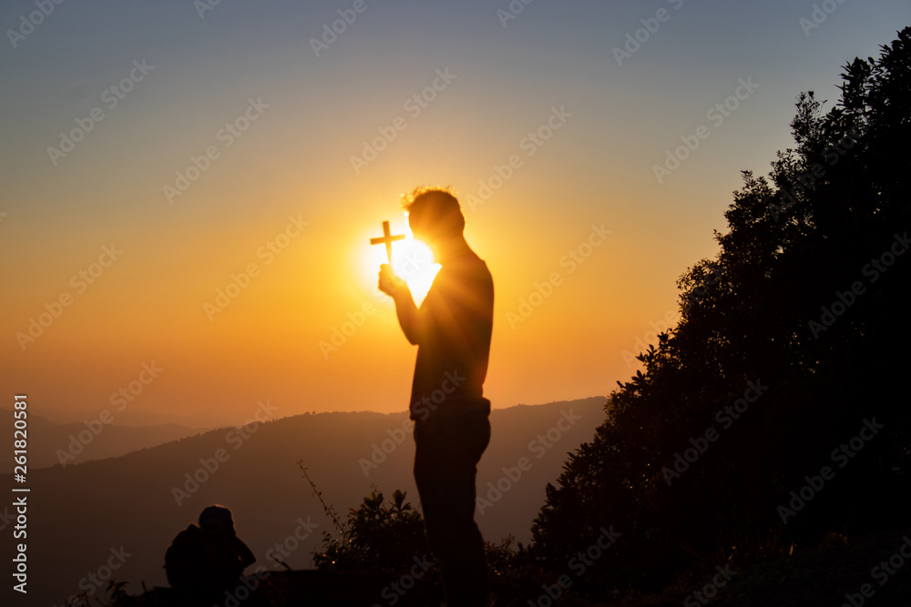 Silhouette of woman praying with cross in nature sunrise background ...