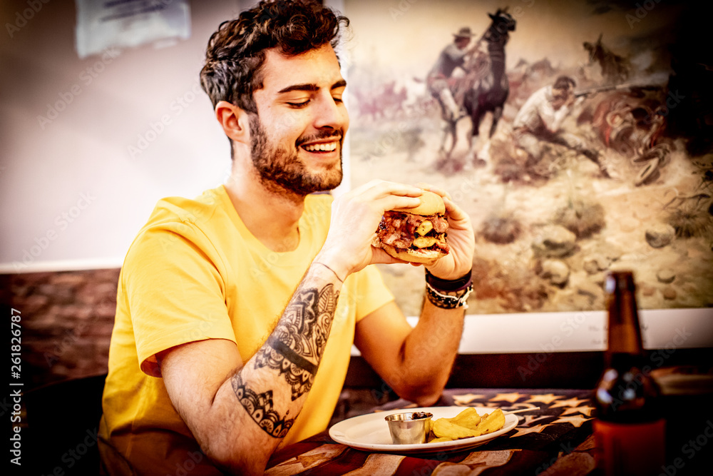 Fast food hamburger with a tattoo guy Stock Photo | Adobe Stock