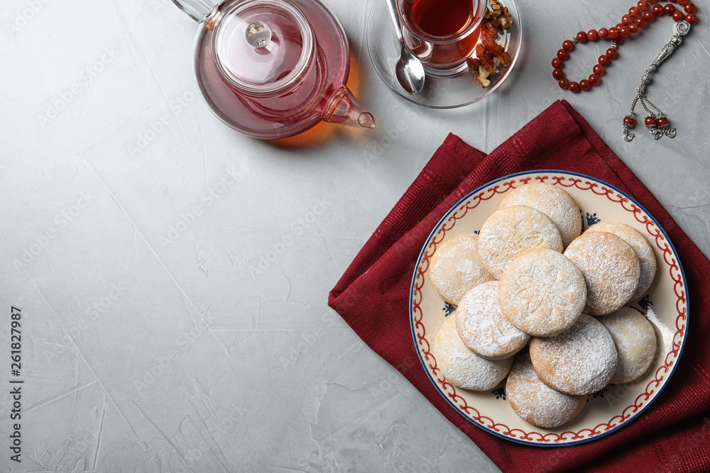 Flat lay composition with plate of traditional Islamic cookies on table ...