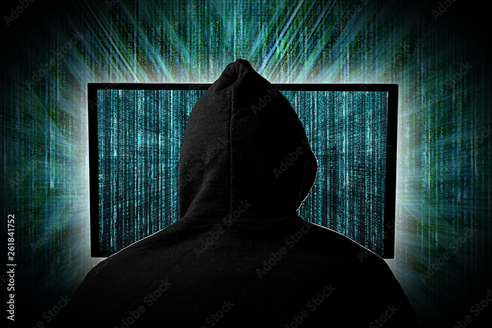 Hacker Behind Glowing Computer Monitor Display In Front Of Green Source Binary Code Background