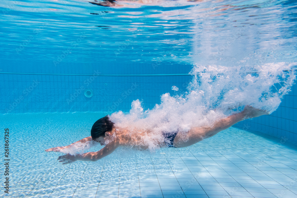 Boy dive in swimming pool Stock Photo | Adobe Stock