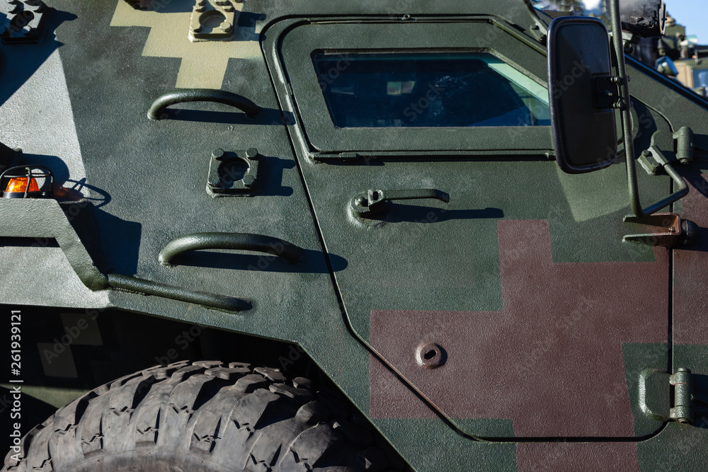 Wheels and front part of the armored personnel carrier. Camouflage ...
