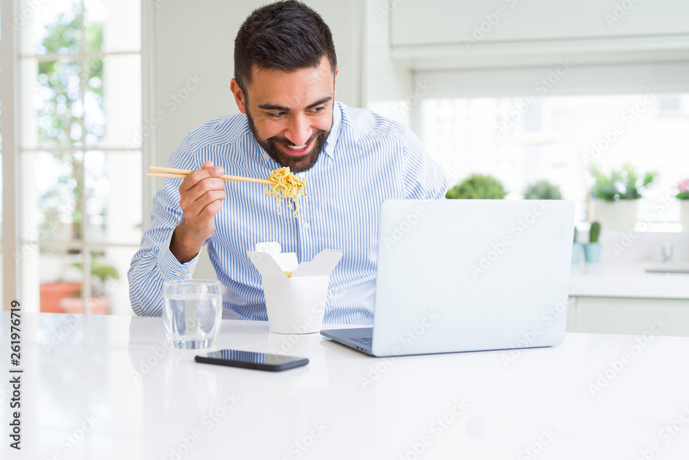 Business man eating asian food from delivery while working using ...