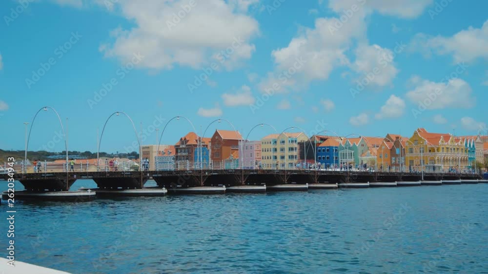 Rising reveal shot of a floating bridge in Willemstad, Curacao, with ...