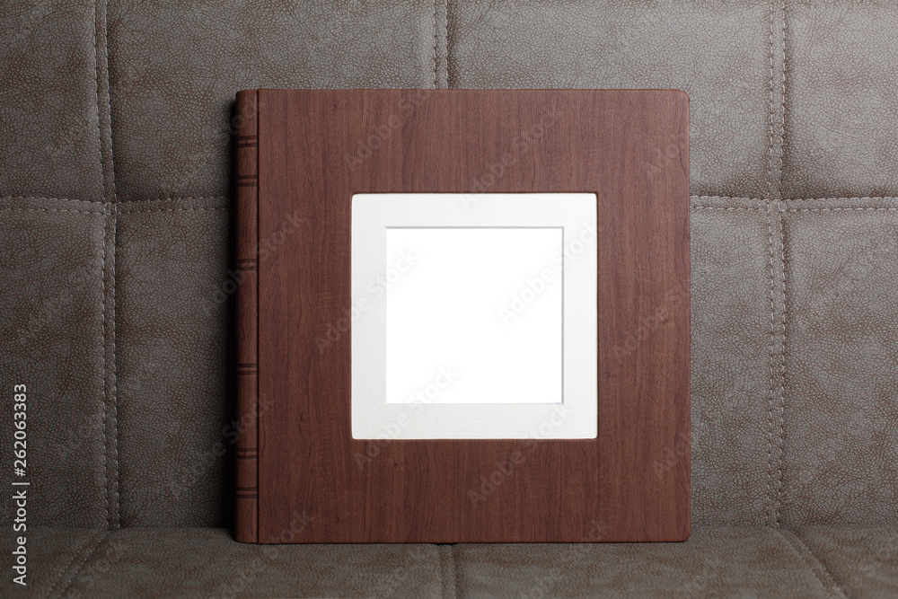 Family photo book with embossing. Photo book on a light background ...