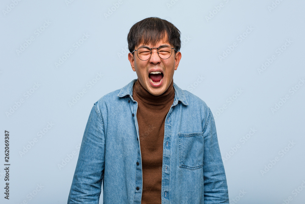 Young chinese man screaming very angry and aggressive Stock Photo ...
