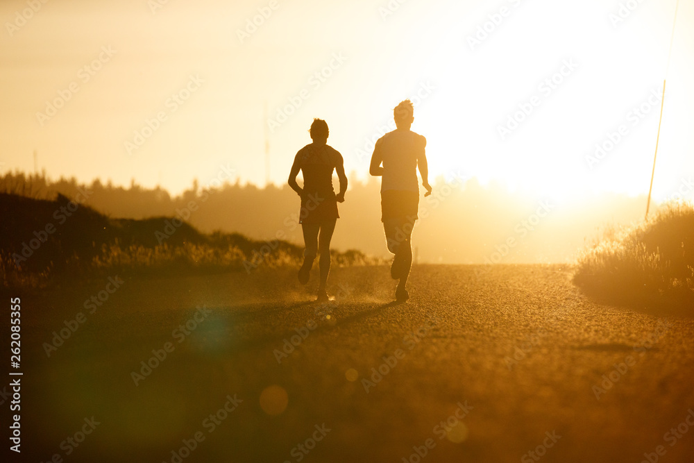 Silhouette of woman and man running at sunset Stock Photo | Adobe Stock