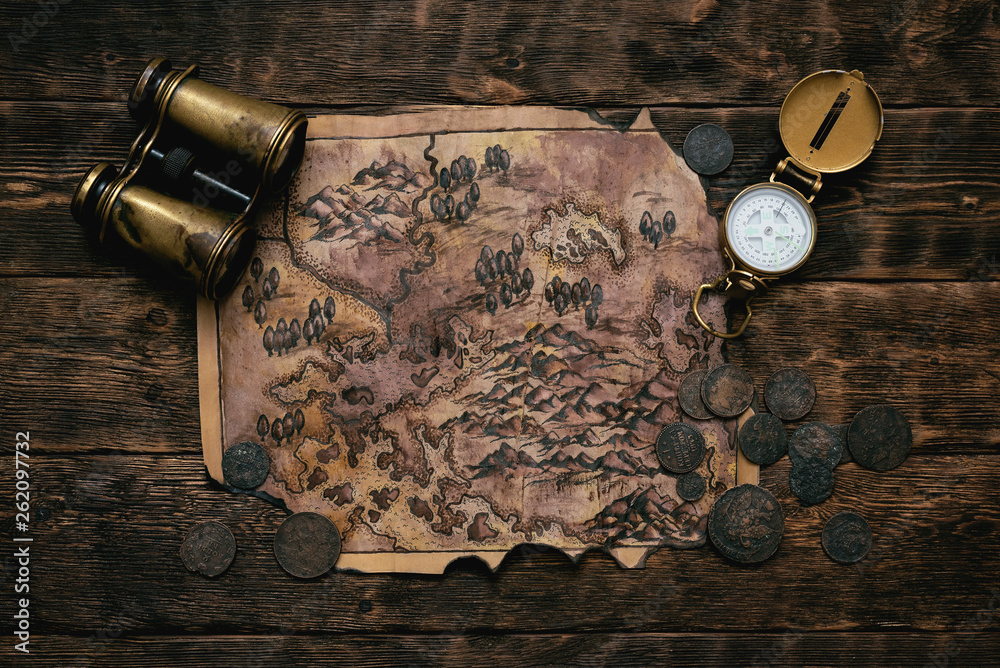 Old map, compass and binoculars on a adventurer table background ...
