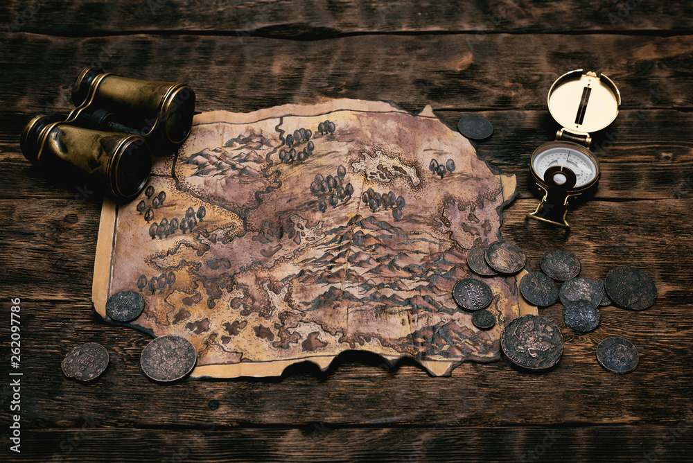 Old map, compass and binoculars on a adventurer table background ...