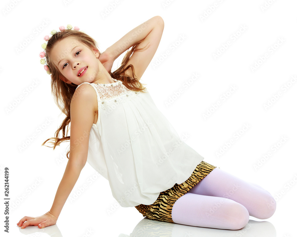 The little girl is on her knees. Stock Photo | Adobe Stock