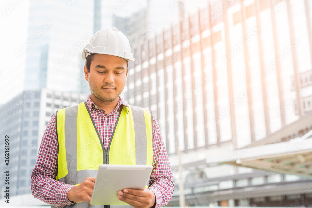 Young civil engineer and construction building background. Stock Photo ...