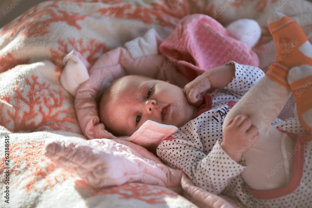 Cute little baby laying on back tries to smile for the first time on ...
