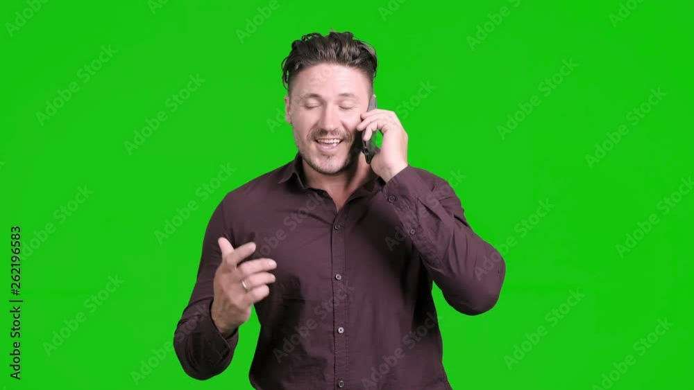 Bearded man using mobile phone with green screen background. Happy ...