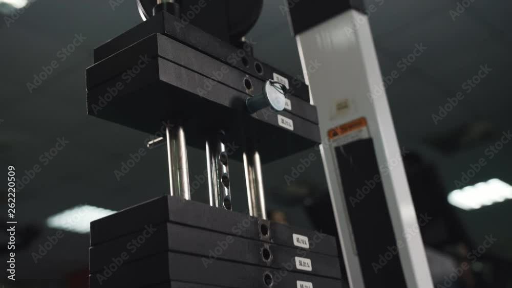 Close-up plates stacked of weight machine with kilogram and pound at ...