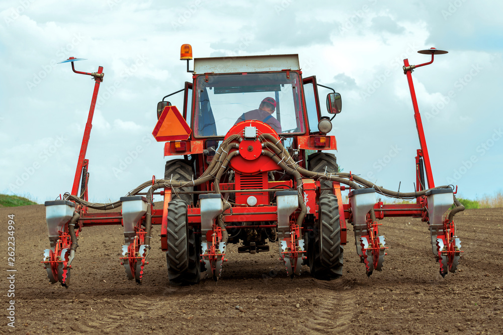 Tractor with mounted crop seeder Stock Photo | Adobe Stock