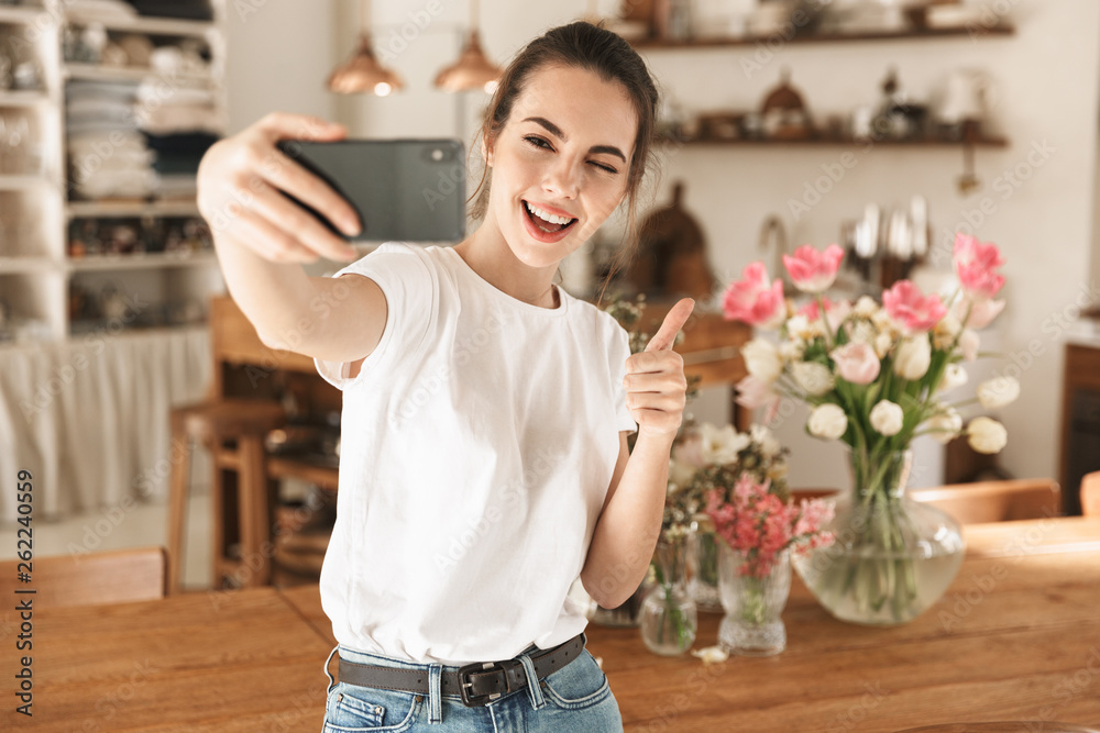 Beautiful young student girl in white t-shirt indoors posing showing ...