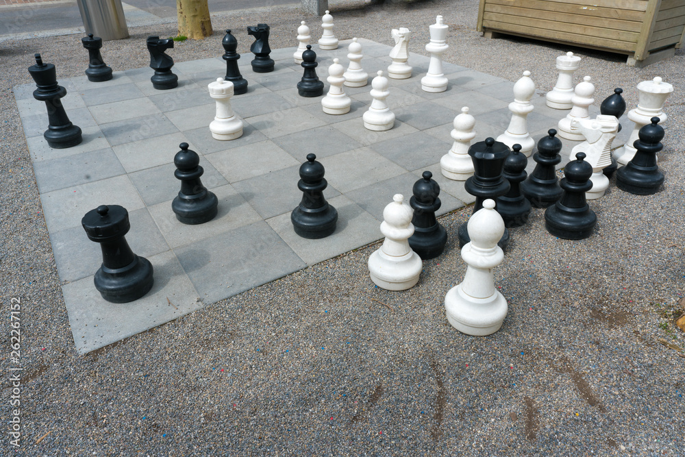 giant chess set and figures in a city square Stock Photo | Adobe Stock