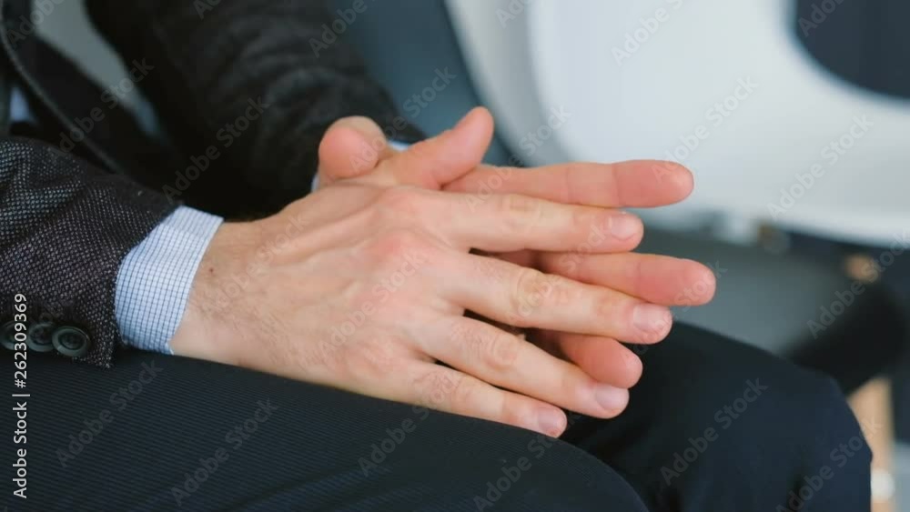 Office man apprehension. Nervous clenching hands closeup. Guy in suit ...