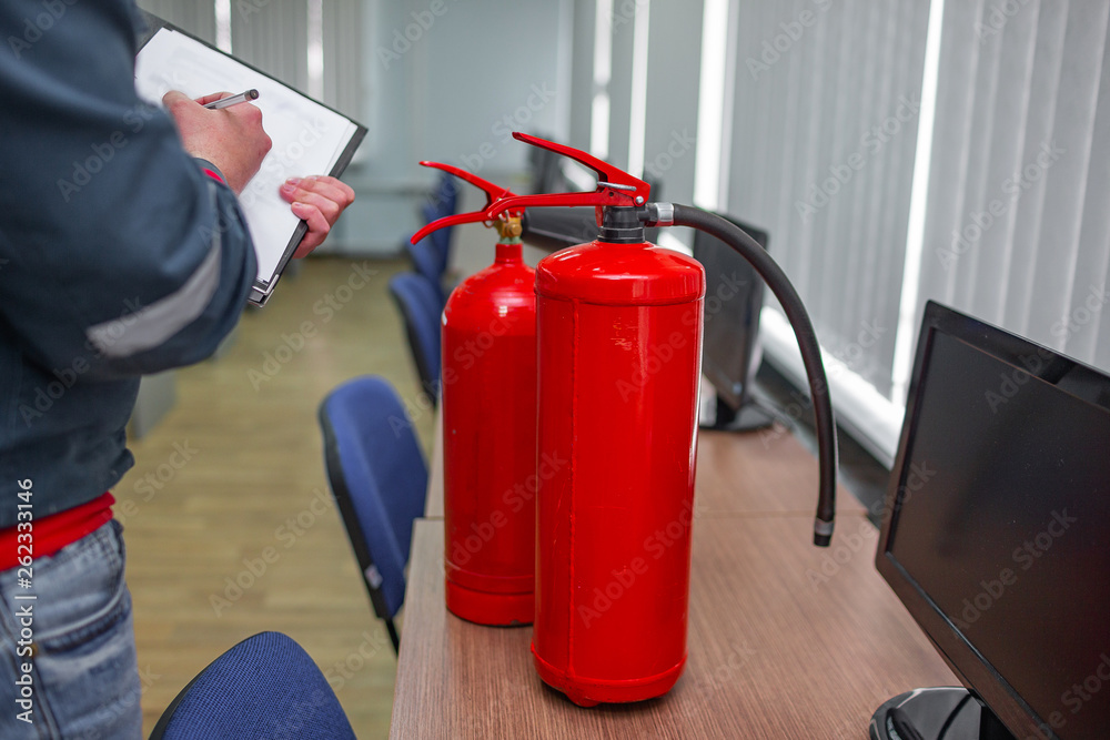 Engineer Professional are Checking A Fire Extinguisher Using Clipboard ...