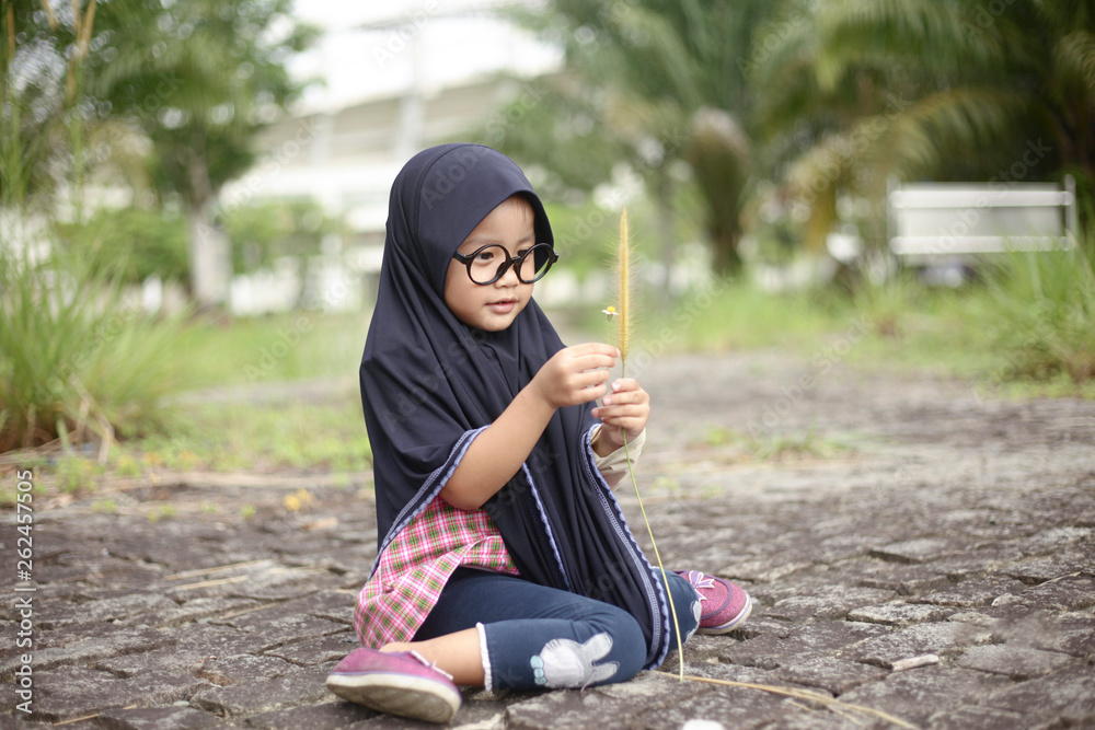 Little Asian Muslim Girl Playing in the Park Stock Photo | Adobe Stock