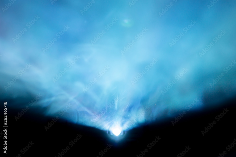 projector spotlight blue color , smoke texture background . light beam ...