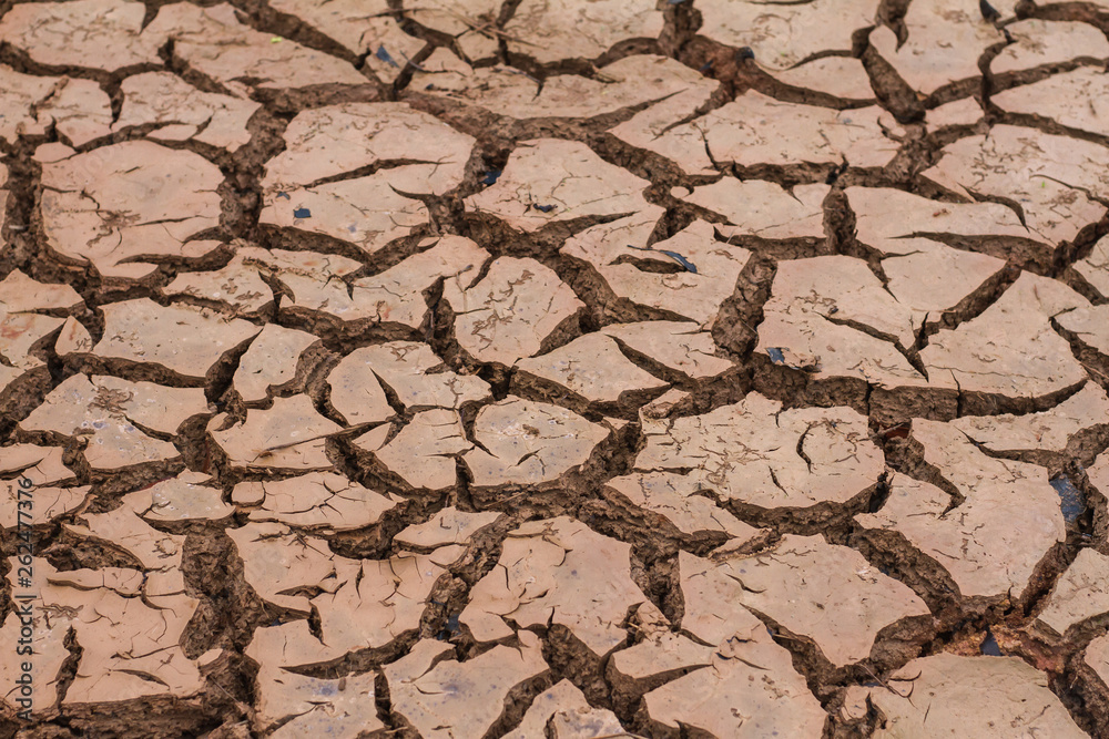 Deep cracks earth in the red land as a symbol of hot climate and ...