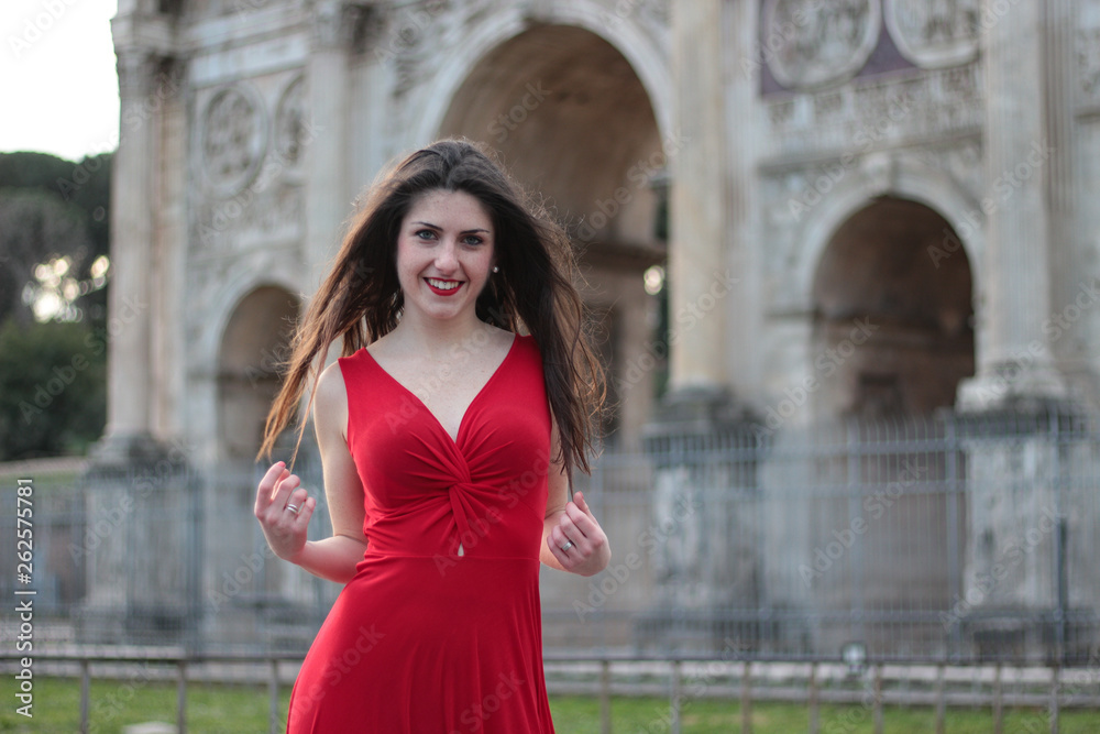 Pretty young girl in red dress in front of Colosseum, Rome, Italy. Rome ...