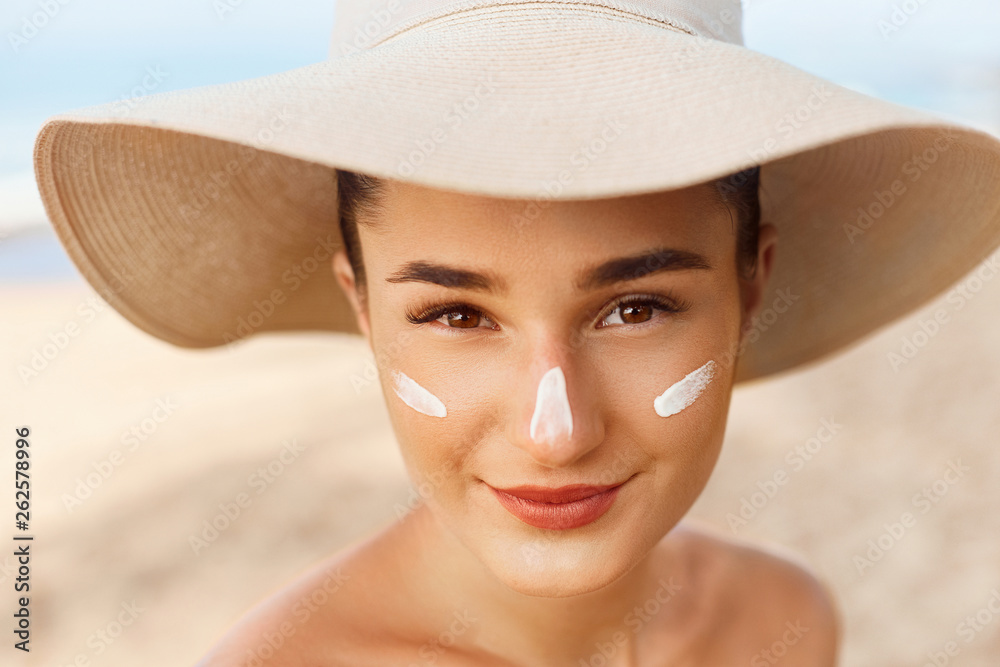 Beautiful Woman smile applying sun cream on face. Skin and Body care ...