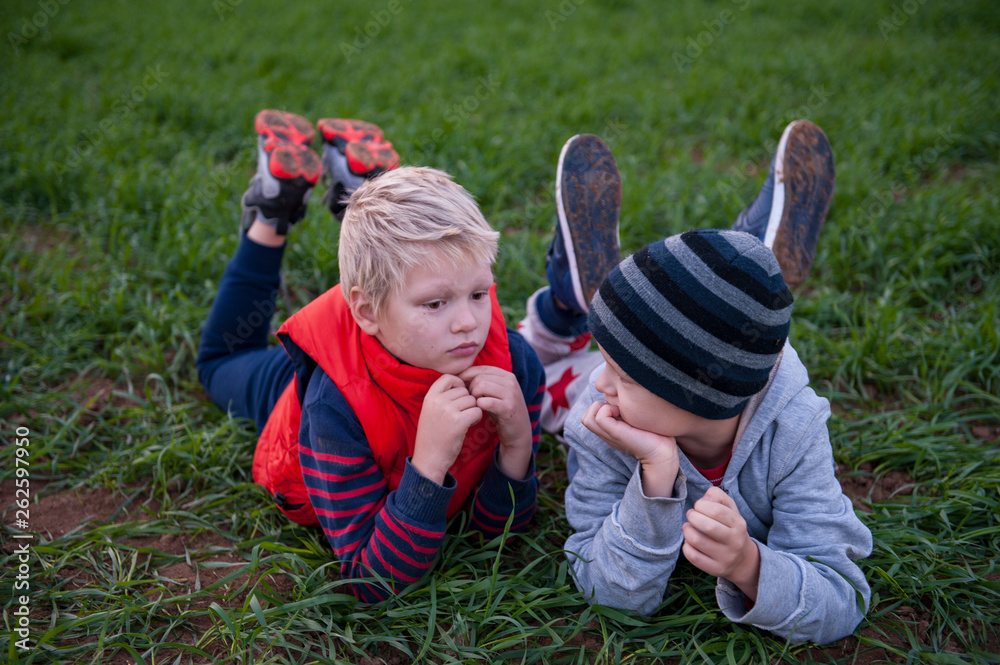 happy children playing in field sown with winter wheat against backdrop ...