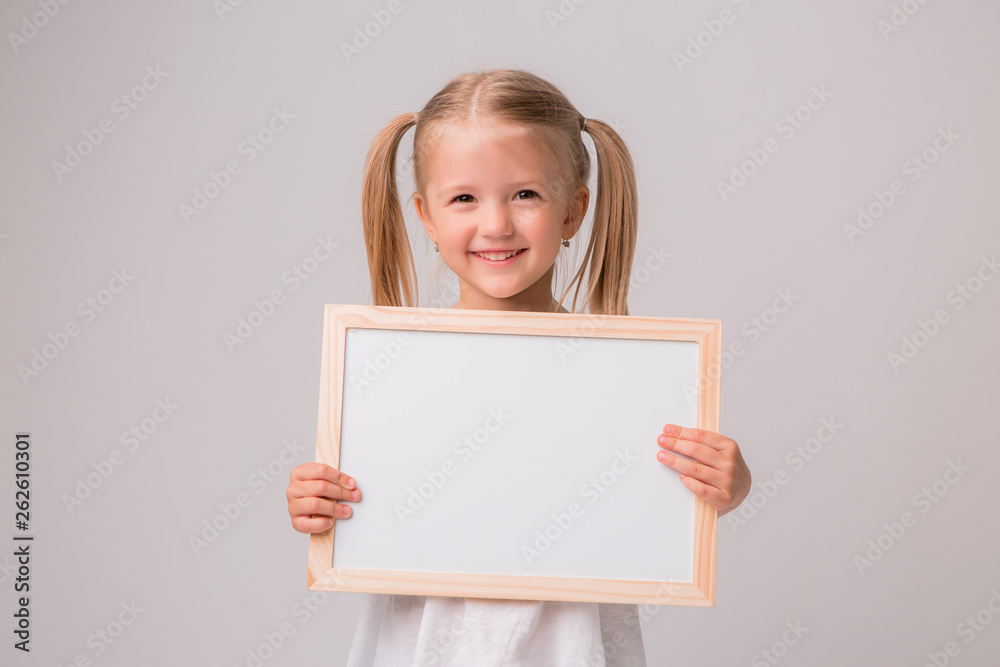 girl holding a white Board .Cute little girl with a white sheet of ...