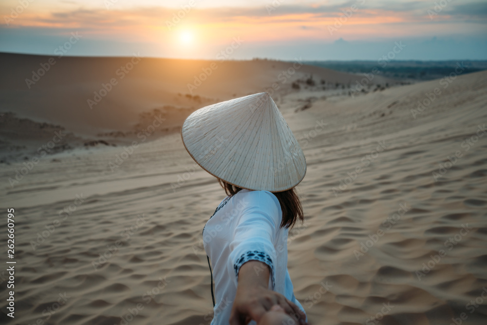 Man's hand holding hands of young woman traveler vietnamese traditional ...