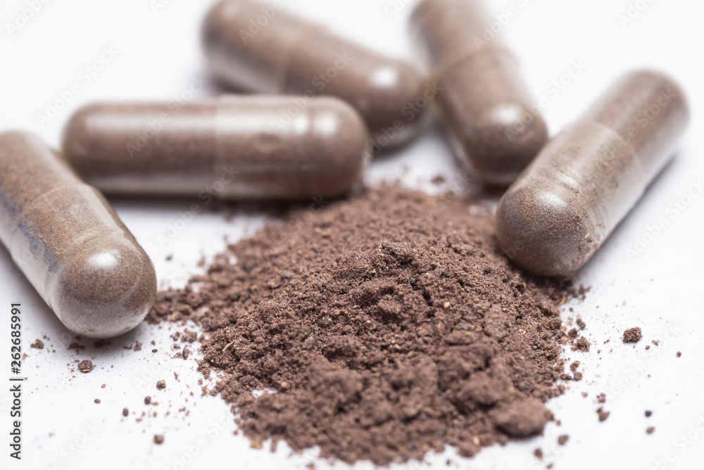 Herbal medicine in capsule isolate on white background. Herb black ...