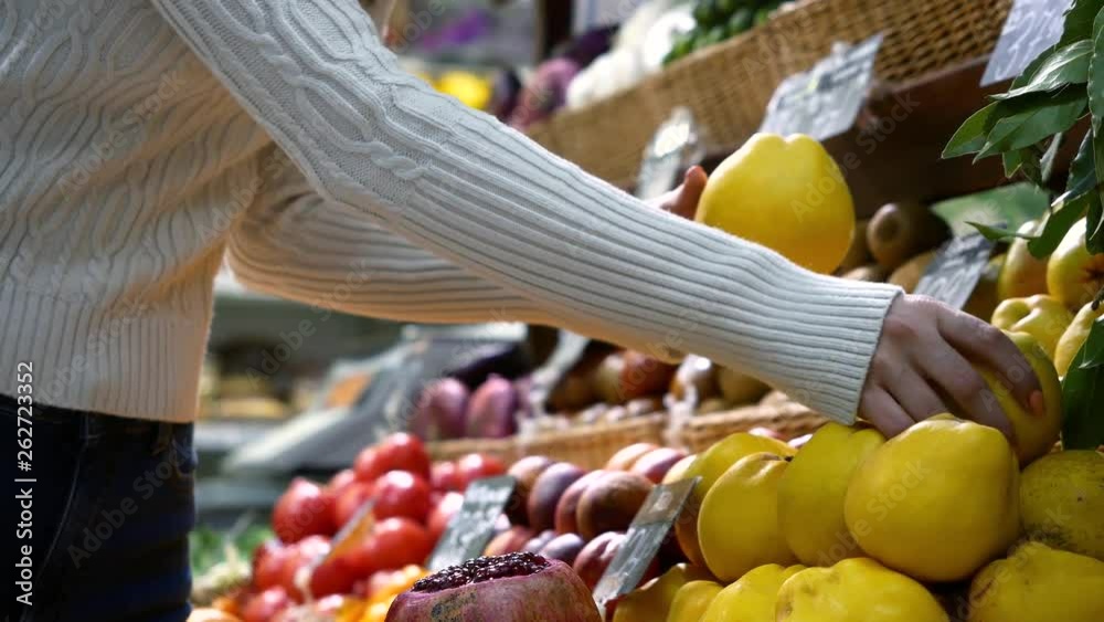 woman in the fruit market with apple in hand. fruits and vegetables. a ...