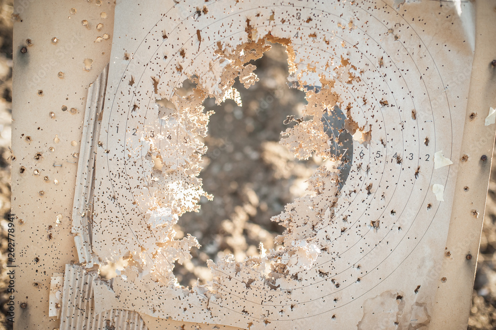 Shooting range target after shooting with shotgun bullet gauge pellets ...