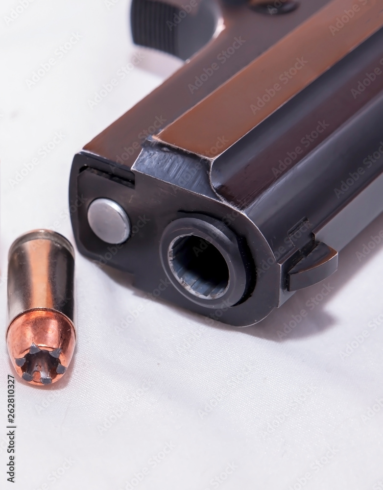 The muzzle of a black 40 caliber pistol with a single 40 caliber hollow ...