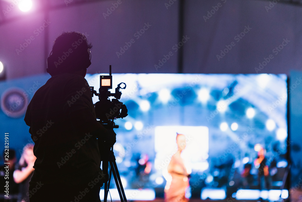 Cameraman silhouette on a live studio news stage.Professional cameraman ...