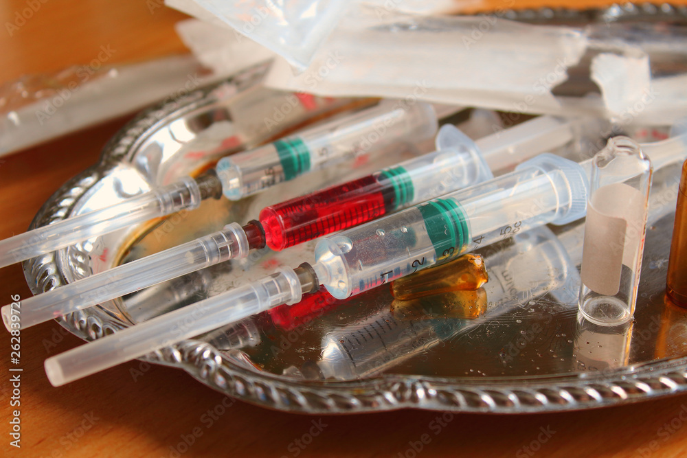 Syringes and vials on a tray. Close-up. Background. Stock Photo | Adobe ...
