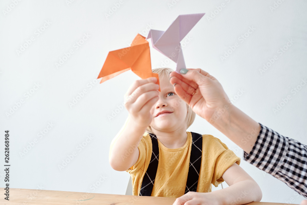 Girl with cute origami doves Stock Photo | Adobe Stock