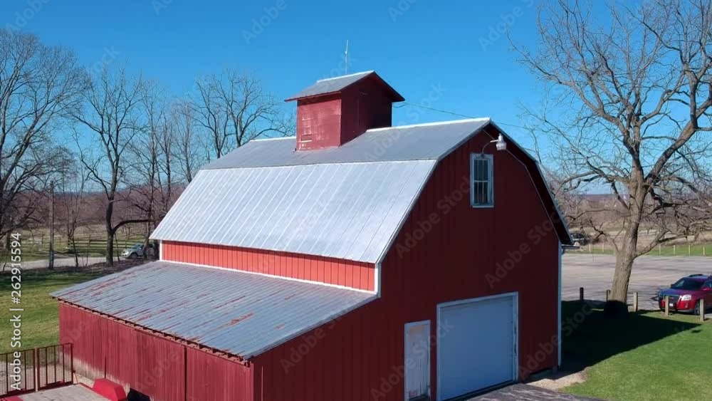 Drone shot showing the height and size of a classic red barn, panning ...